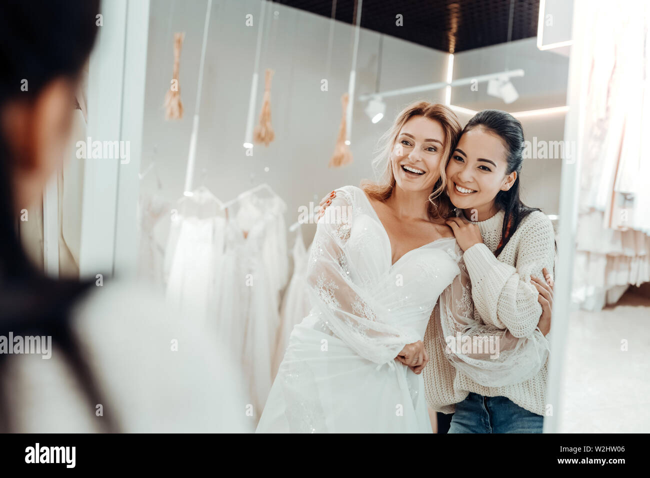 Beautiful bride hugging her maid of honour Stock Photo - Alamy