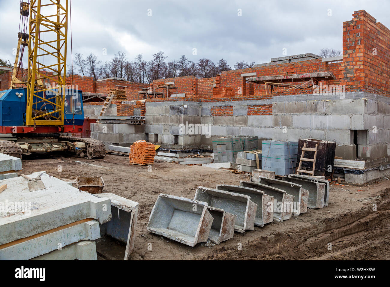 Construction site, tools, wheel barrow, sand and bricks at new house ...