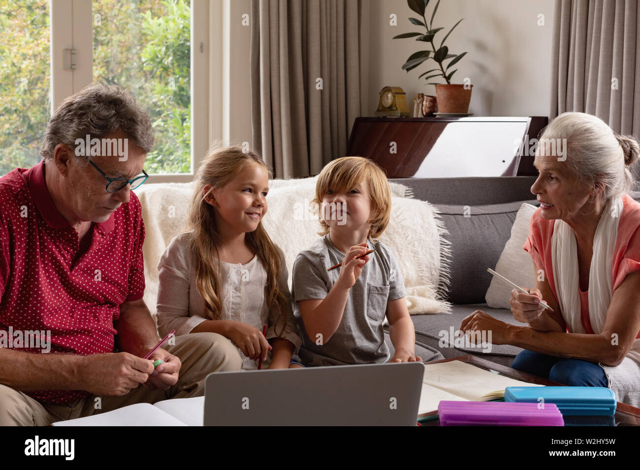 Child helping elderly hi-res stock photography and images - Alamy