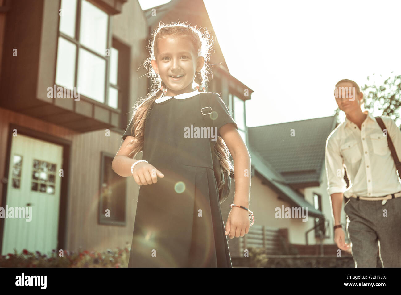 Cute long-haired girl with wide smile wearing strict school uniform ...