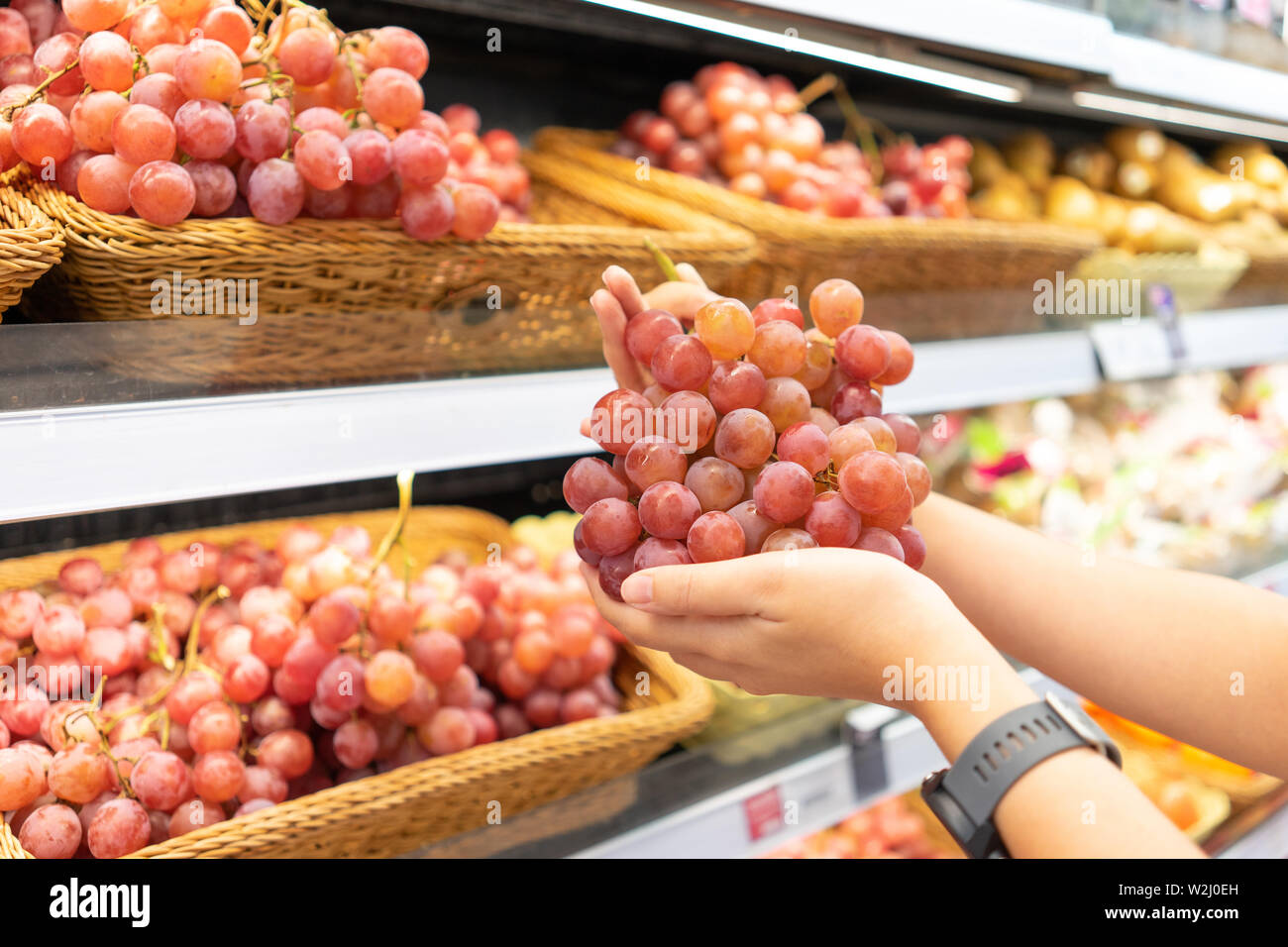 Hands that are picking fruits and vegetables from the shelf to select ...