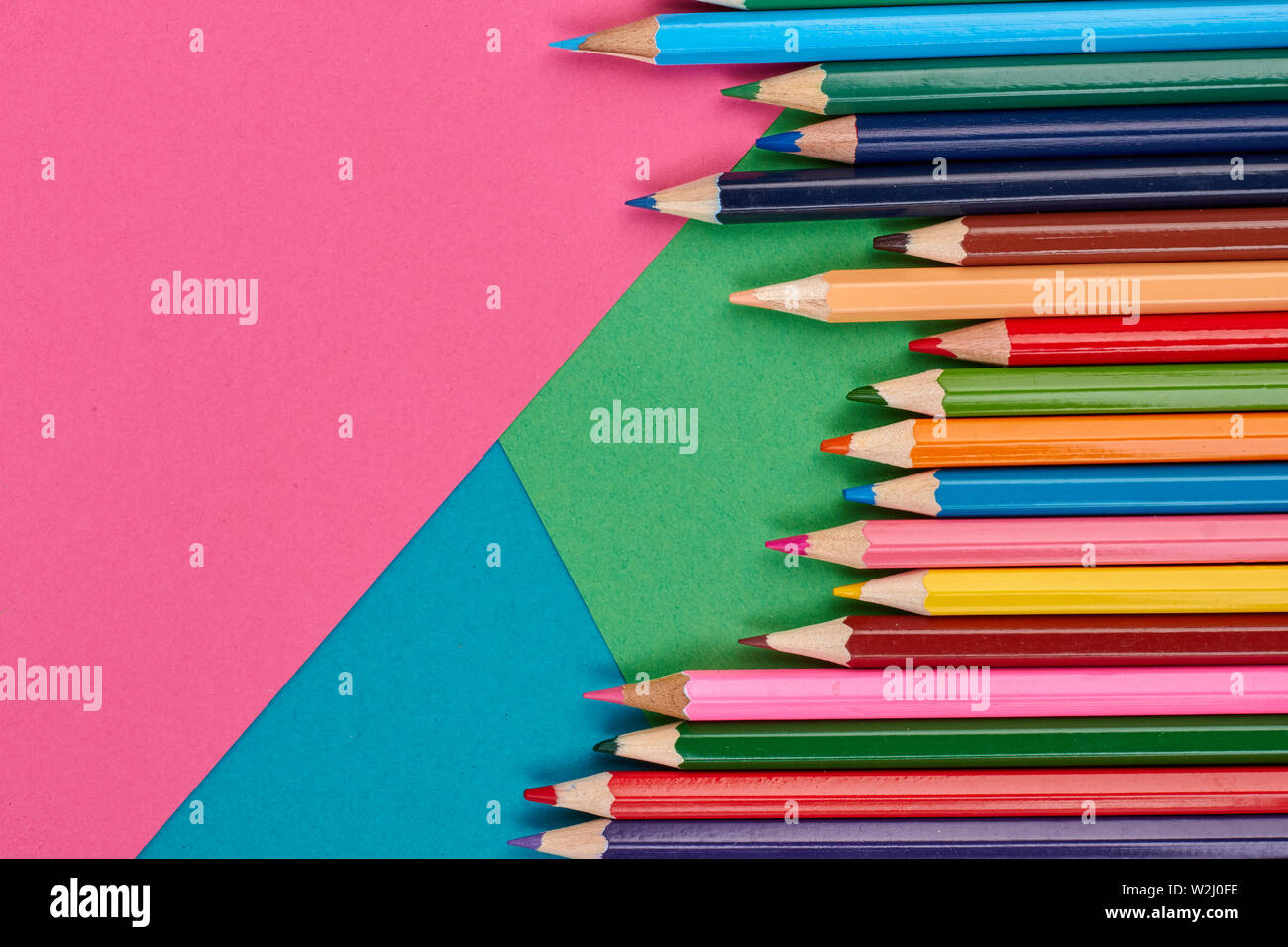 Multi-colored pencils on color background Stock Photo - Alamy