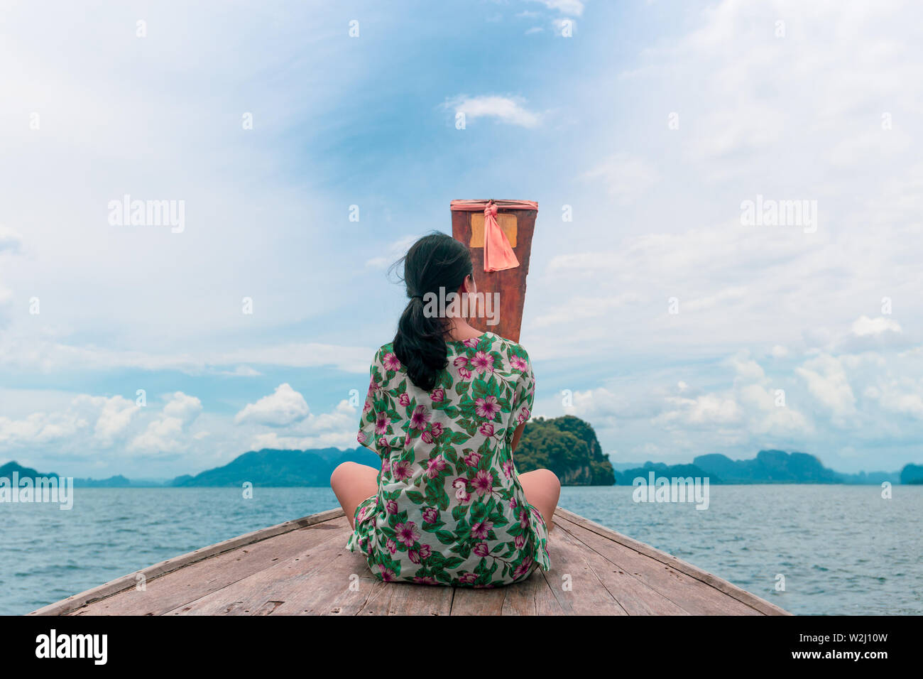 Caucasian Woman sit on boat out in the ocean rear view Stock Photo - Alamy