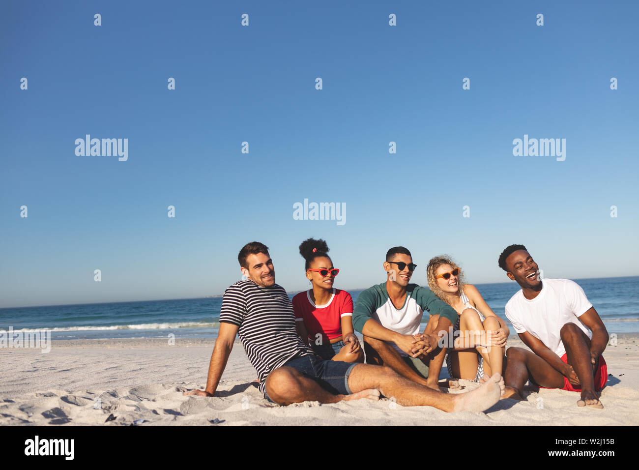 Group of friends having fun together on the beach Stock Photo - Alamy