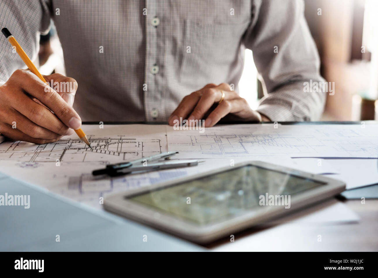 Confident engineer team working with Blue Print with architect ...