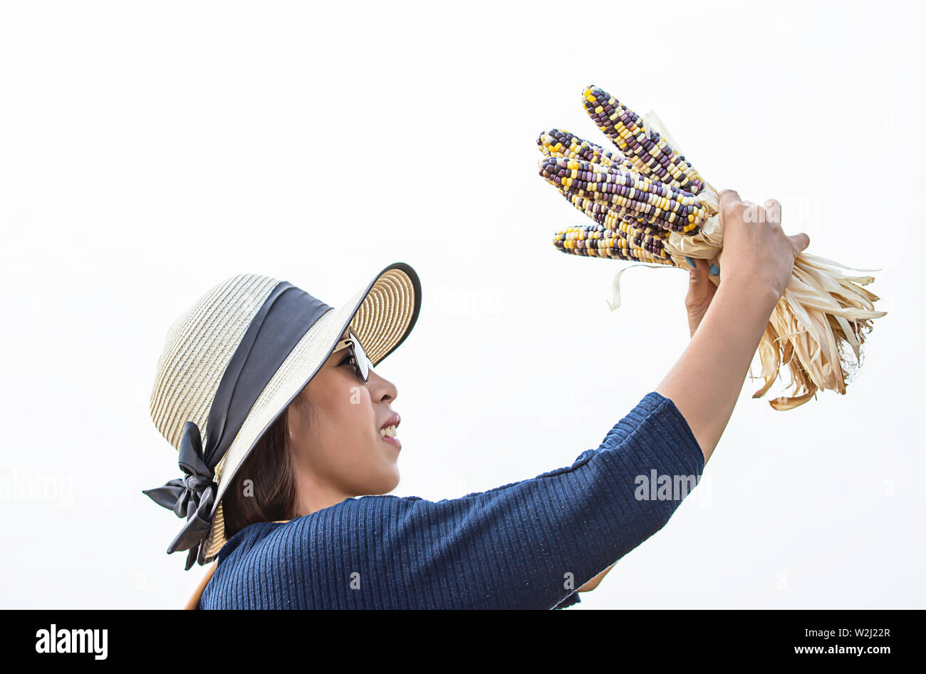 A woman holding the corn at the show in the farm Stock Photo - Alamy