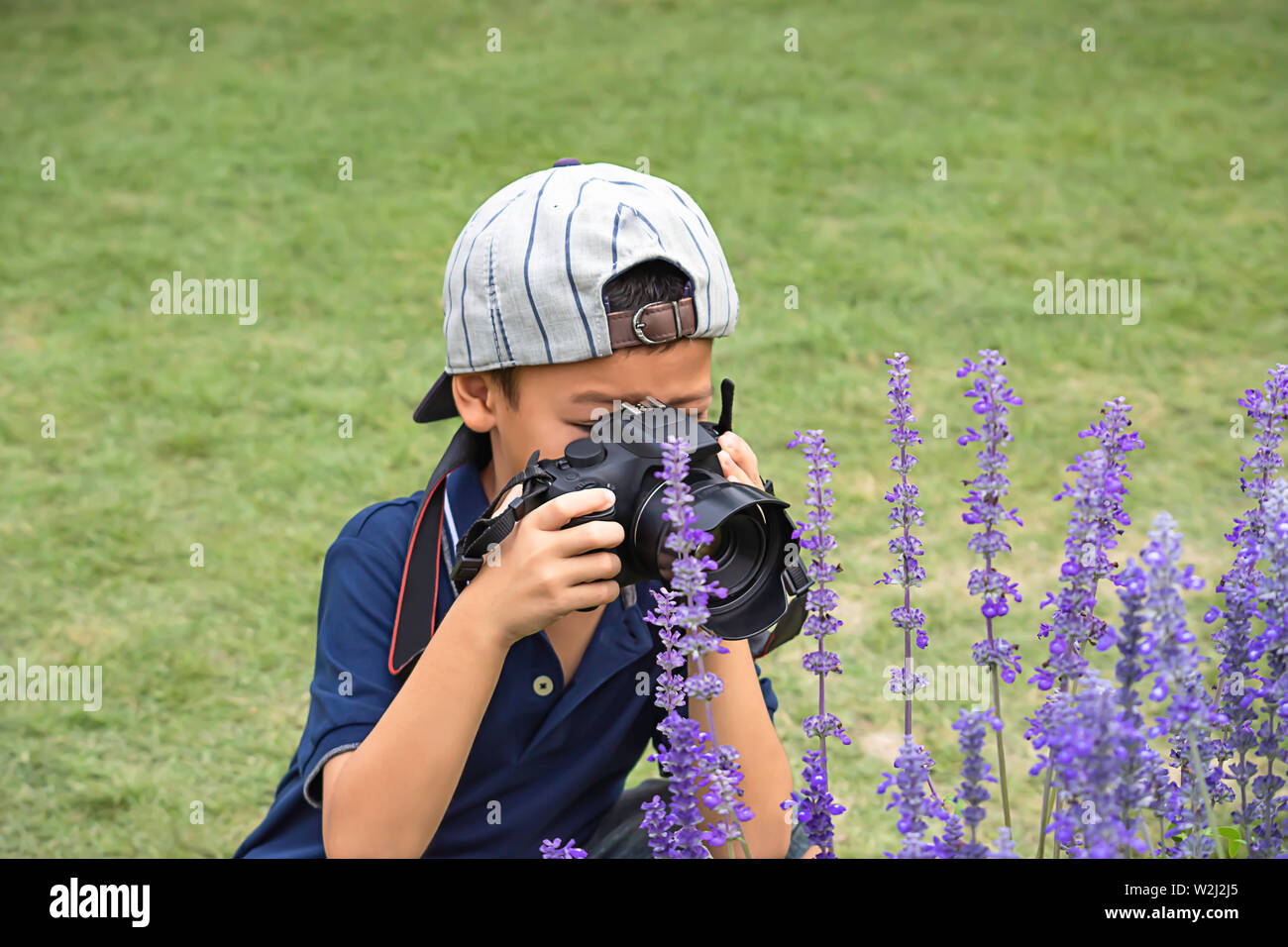 Hand boy holding the camera Taking pictures in park Stock Photo - Alamy