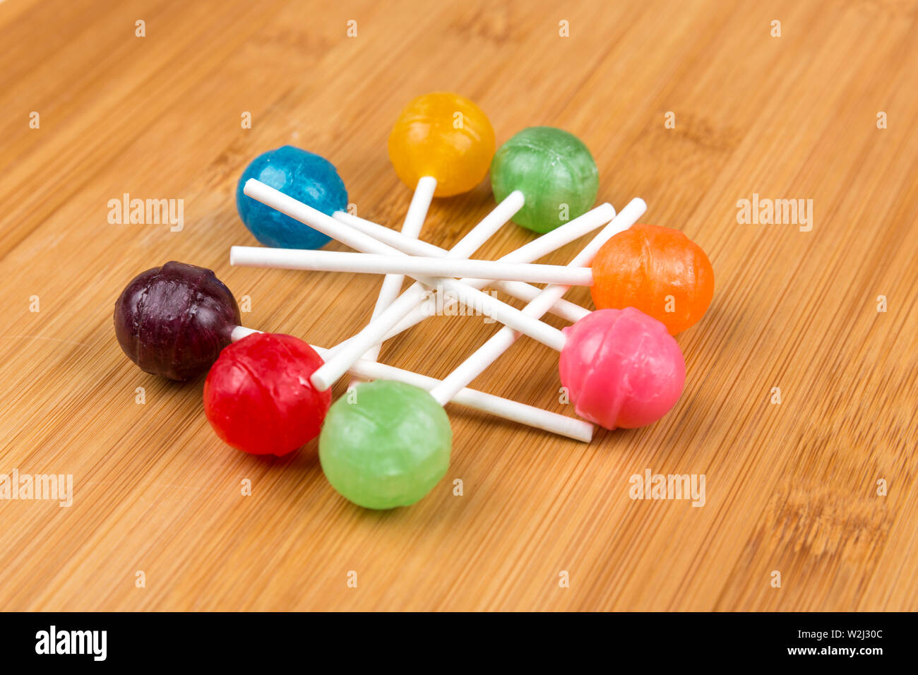 Colorful arrangement of candy suckers on sticks Stock Photo - Alamy