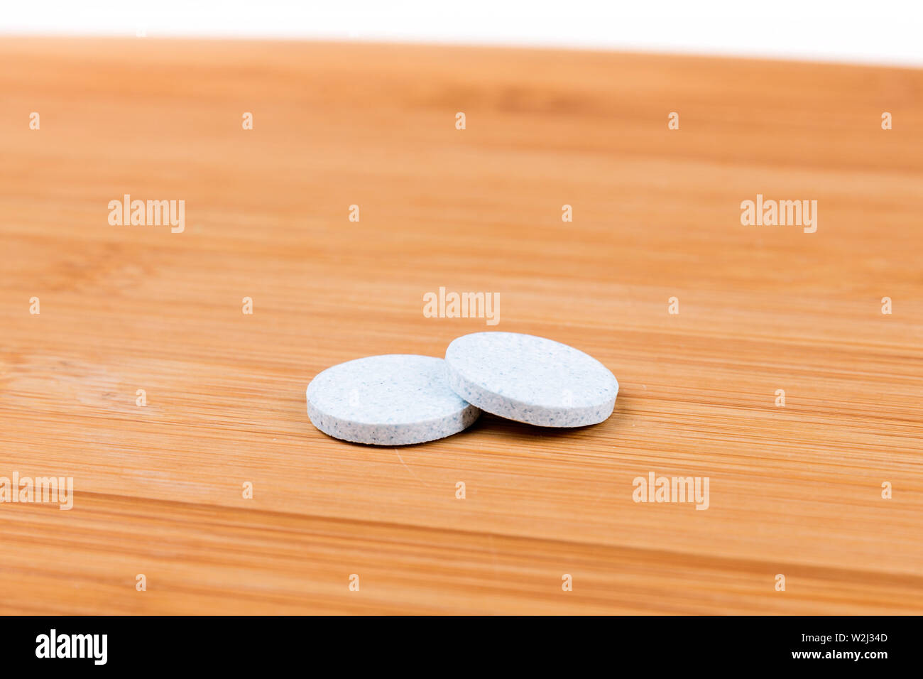Dental fizzy teeth cleaning tabs on a wooden background Stock Photo - Alamy