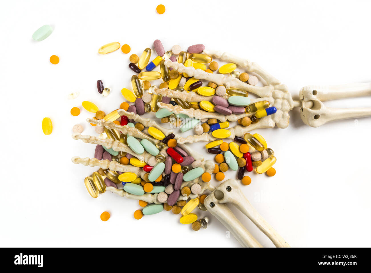 White bony skeleton hands palms up holding a handful of pills Stock ...