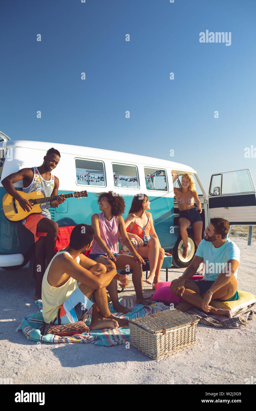 Group of friends having fun near camper van at beach Stock Photo - Alamy