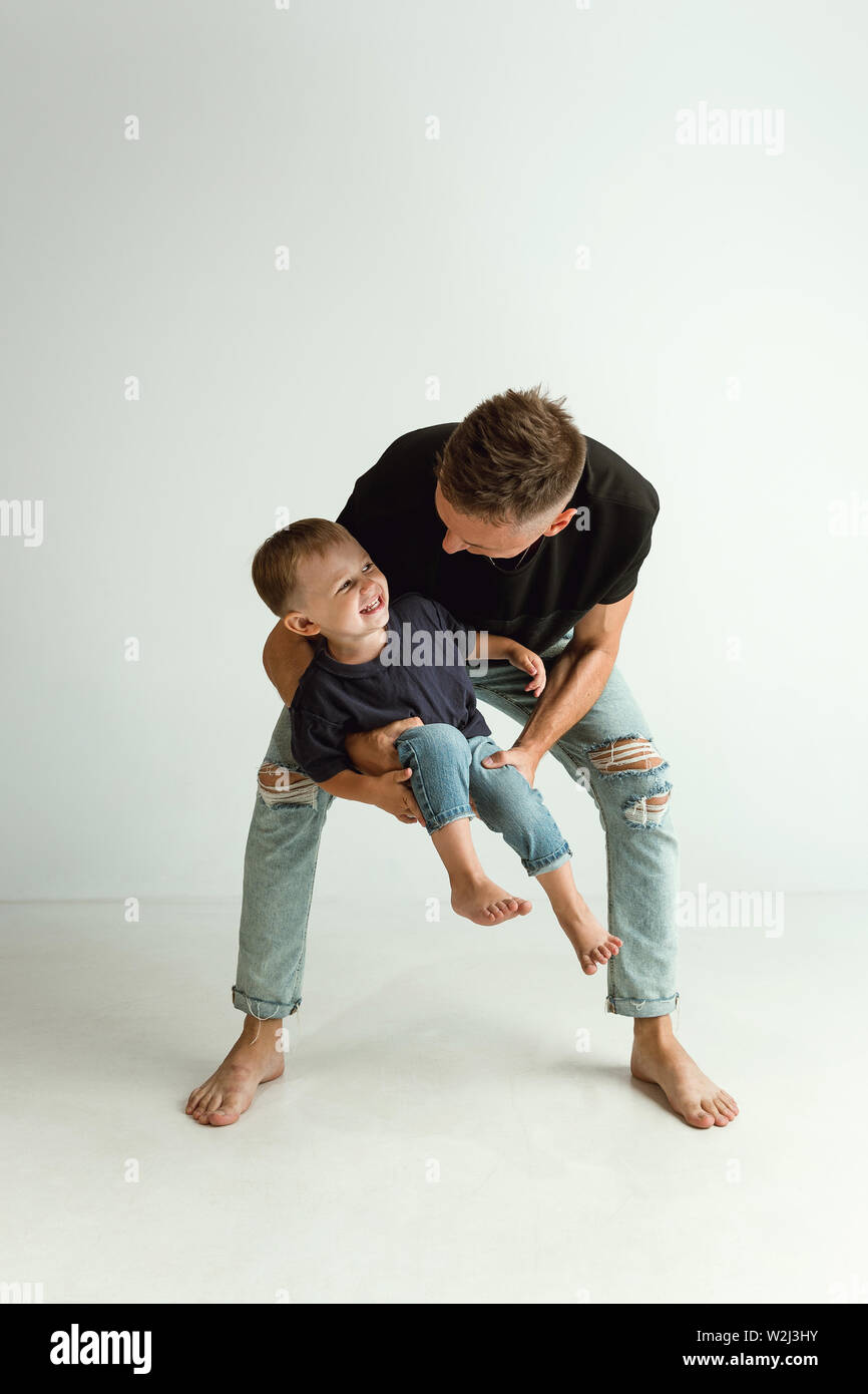 Happy father holding adorable little son and smiling at camera. Young ...