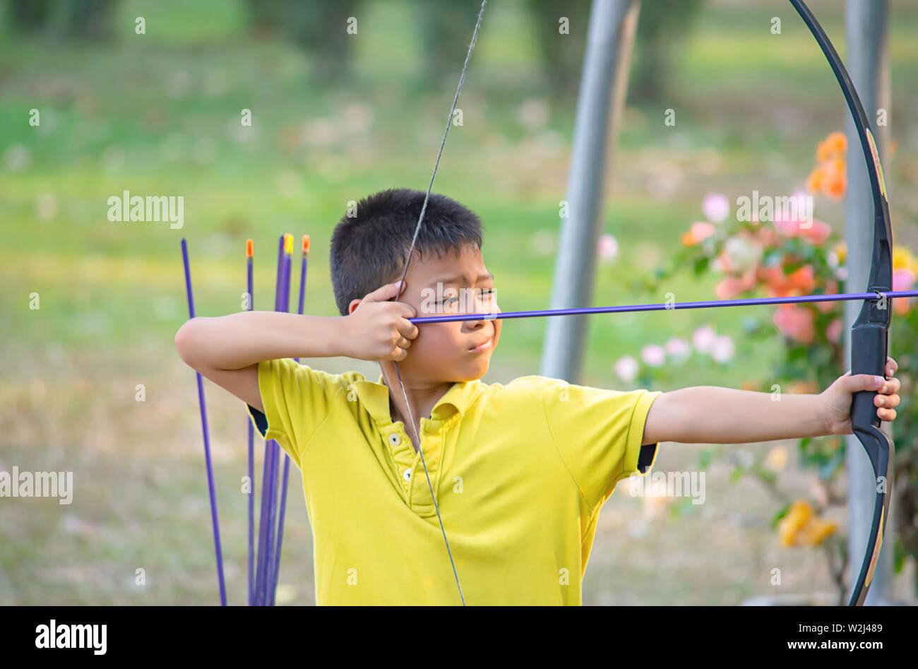 Asian boys are archery in camp adventure Stock Photo - Alamy