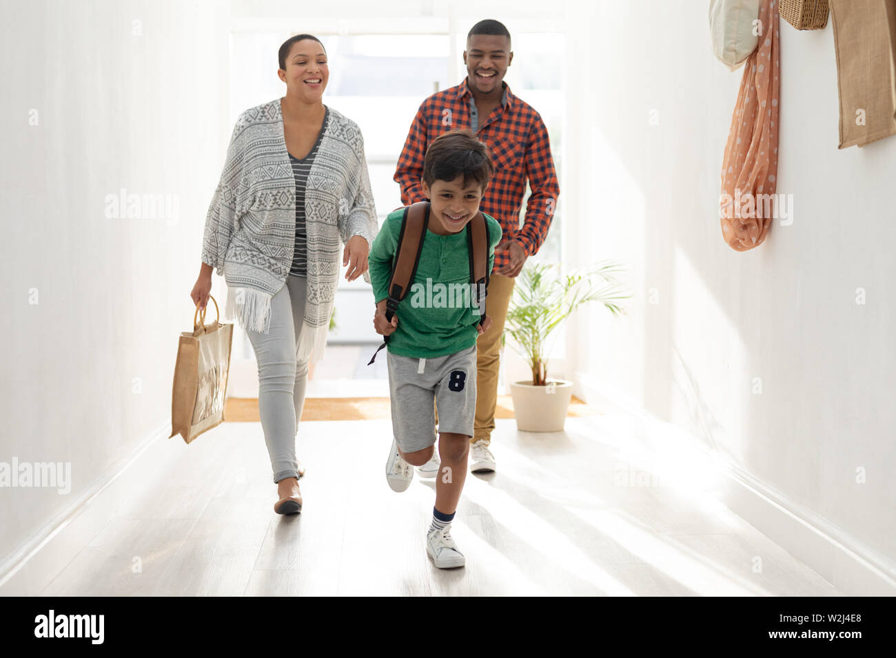Family entering their home Stock Photo - Alamy