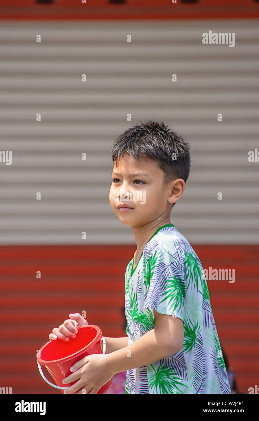 Asian boy holding Plastic bucket play Songkran festival or Thai new ...