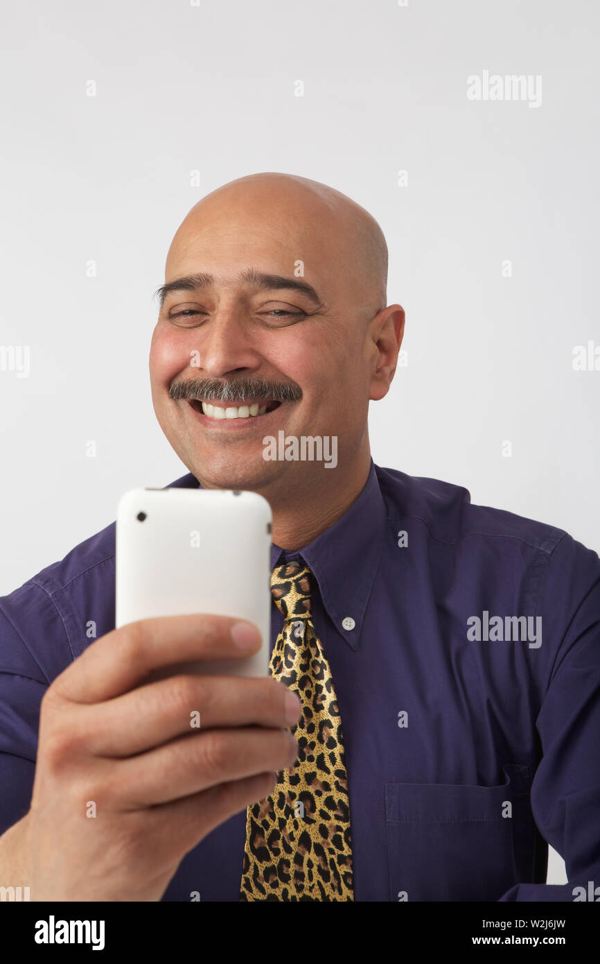 Indian bald businessman text messaging Stock Photo - Alamy