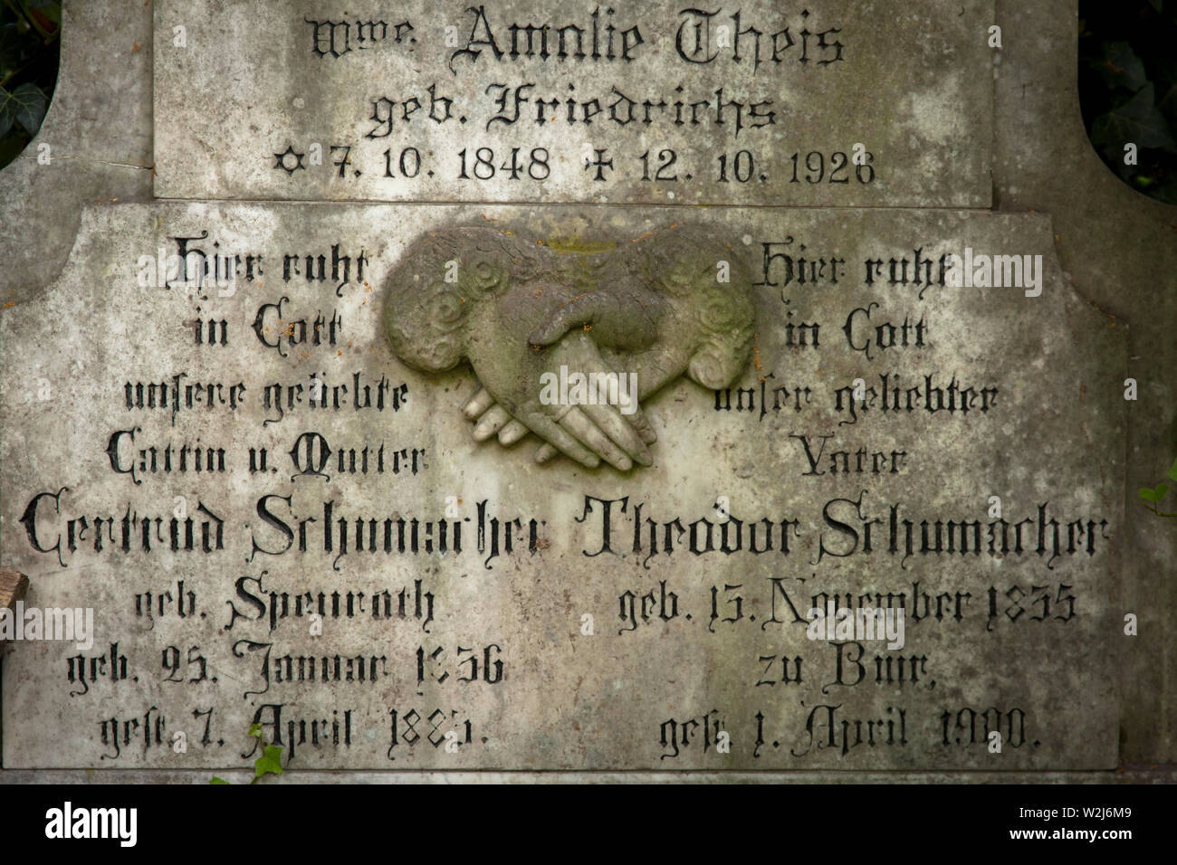 at the Melaten cemetery, hands on a tombstone, Cologne, Germany. auf ...