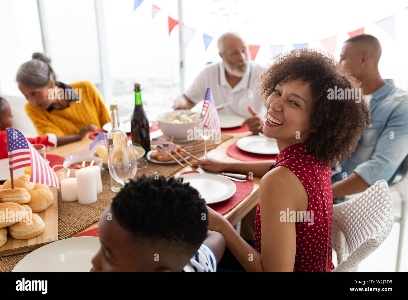 Multi-generation family sitting together for having meal on dining ...