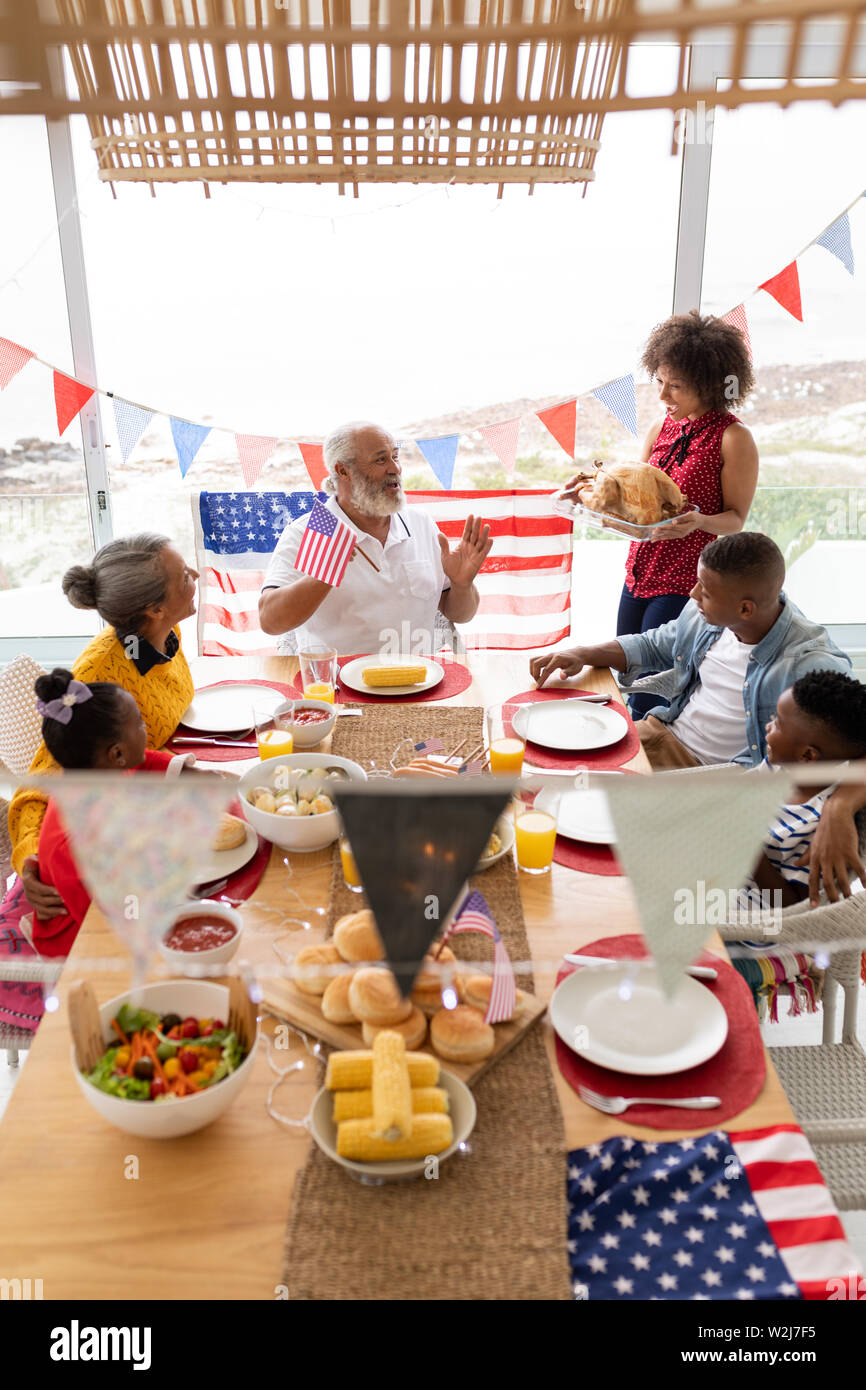 Multi-generation family having food together on a dining table Stock ...