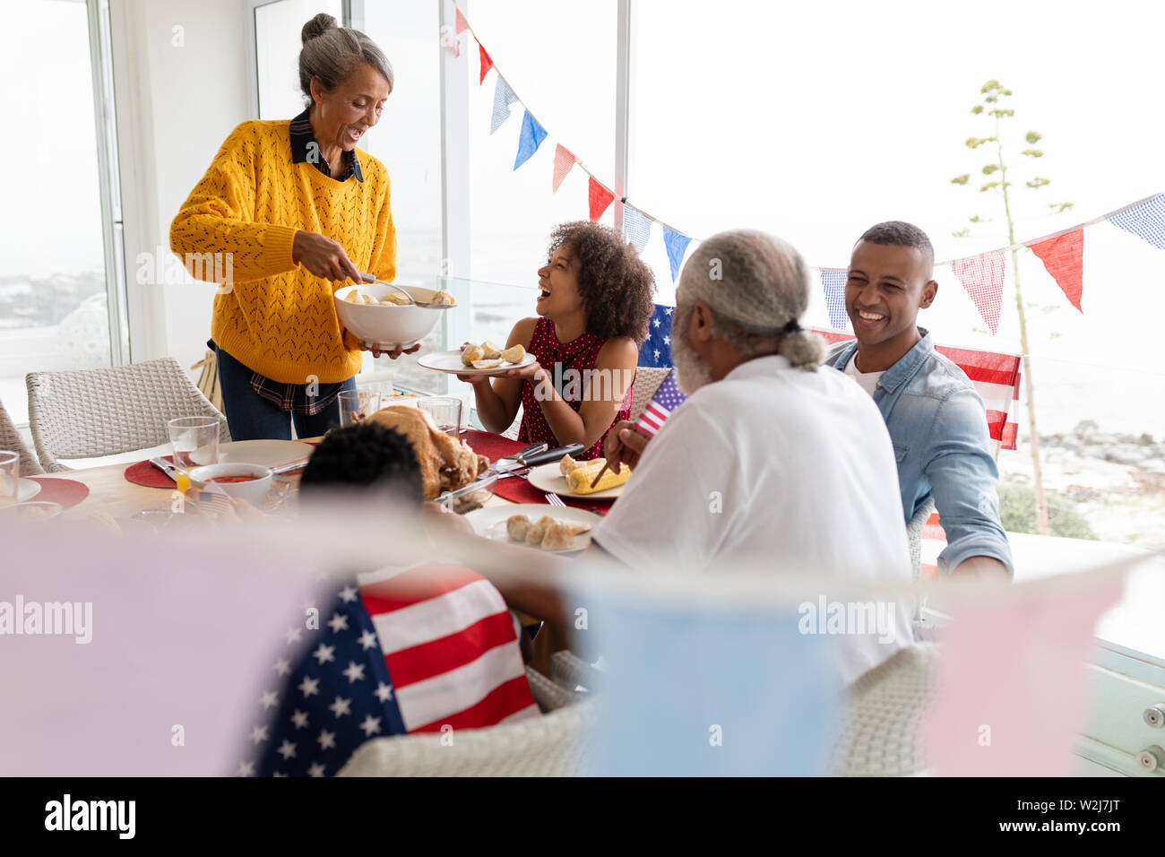 Multi-generation family having meal on a dining table Stock Photo - Alamy