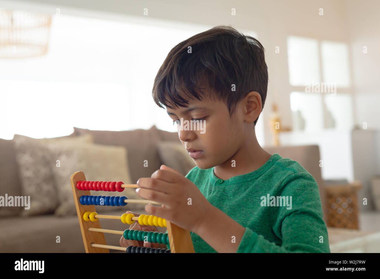 Boy learning mathematics with abacus in a comfortable home Stock Photo ...
