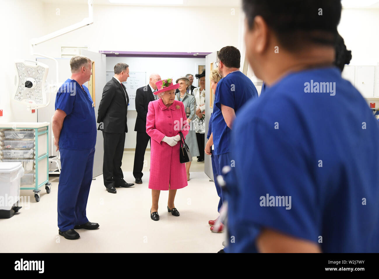 Queen Elizabeth II meets members of staff during a visit to Royal ...
