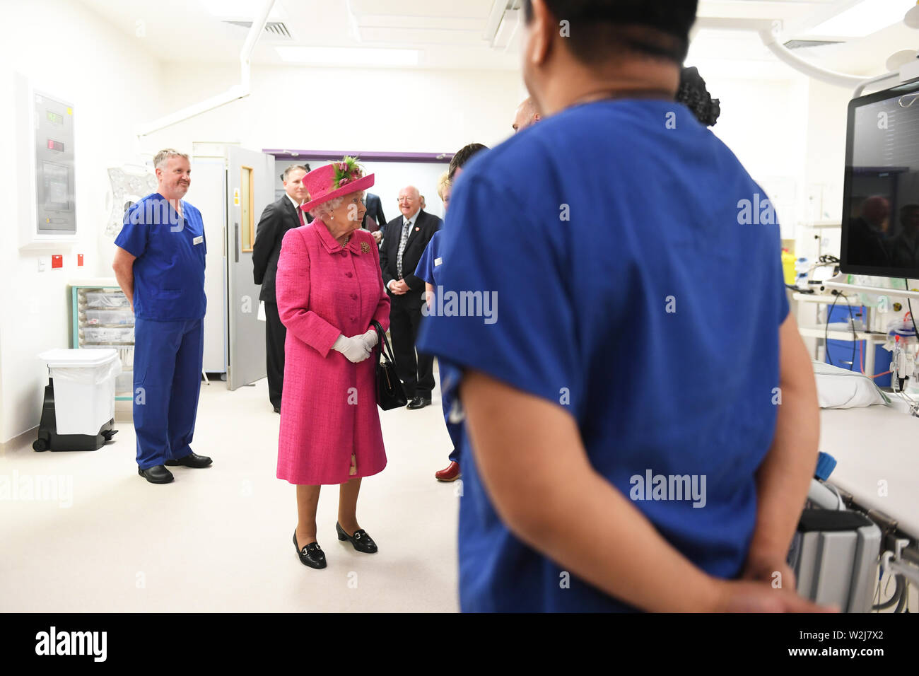 Queen Elizabeth II meets members of staff during a visit to Royal ...