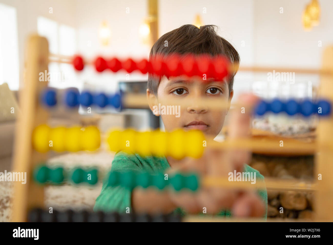Boy learning mathematics with abacus in a comfortable home Stock Photo ...