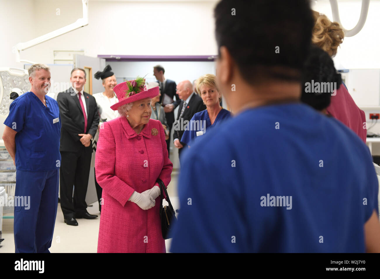 Queen Elizabeth II meets members of staff during a visit to Royal ...
