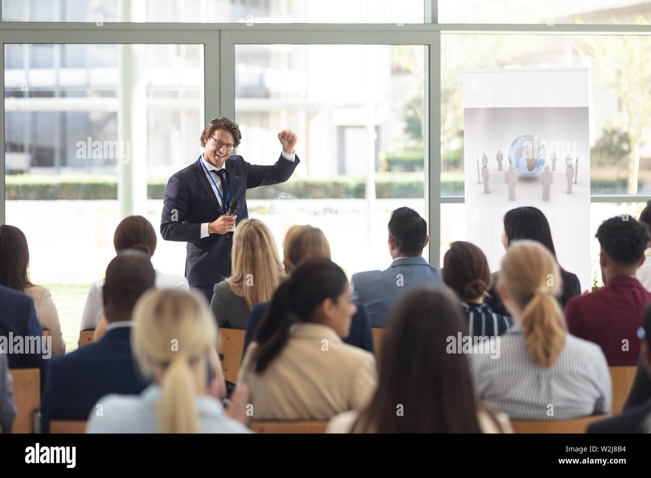 Mature Caucasian male executive doing speech in conference room ...