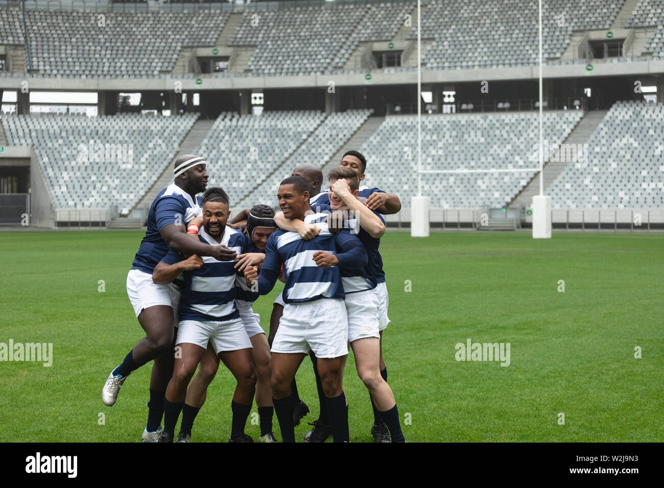 Group of diverse male rugby players celebrating goal in stadium Stock ...