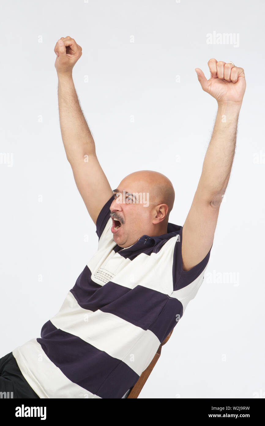 Indian man shouting with arms raised Stock Photo - Alamy