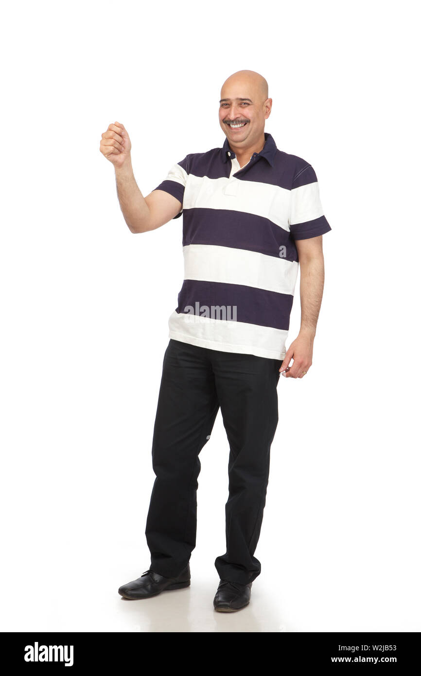 Portrait of a man standing and smiling Stock Photo - Alamy