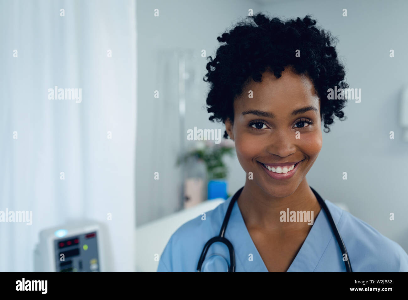Female doctor smiling in the ward at hospital Stock Photo - Alamy