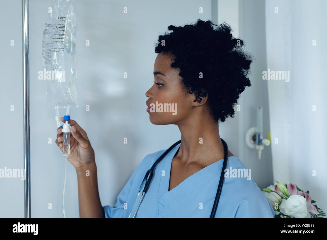Female doctor adjusting iv drip in the ward at hospital Stock Photo - Alamy
