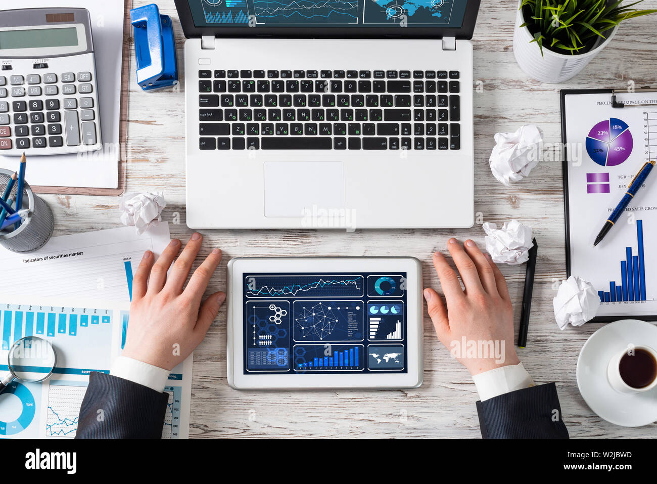 Businessman working at office desk with data Stock Photo - Alamy