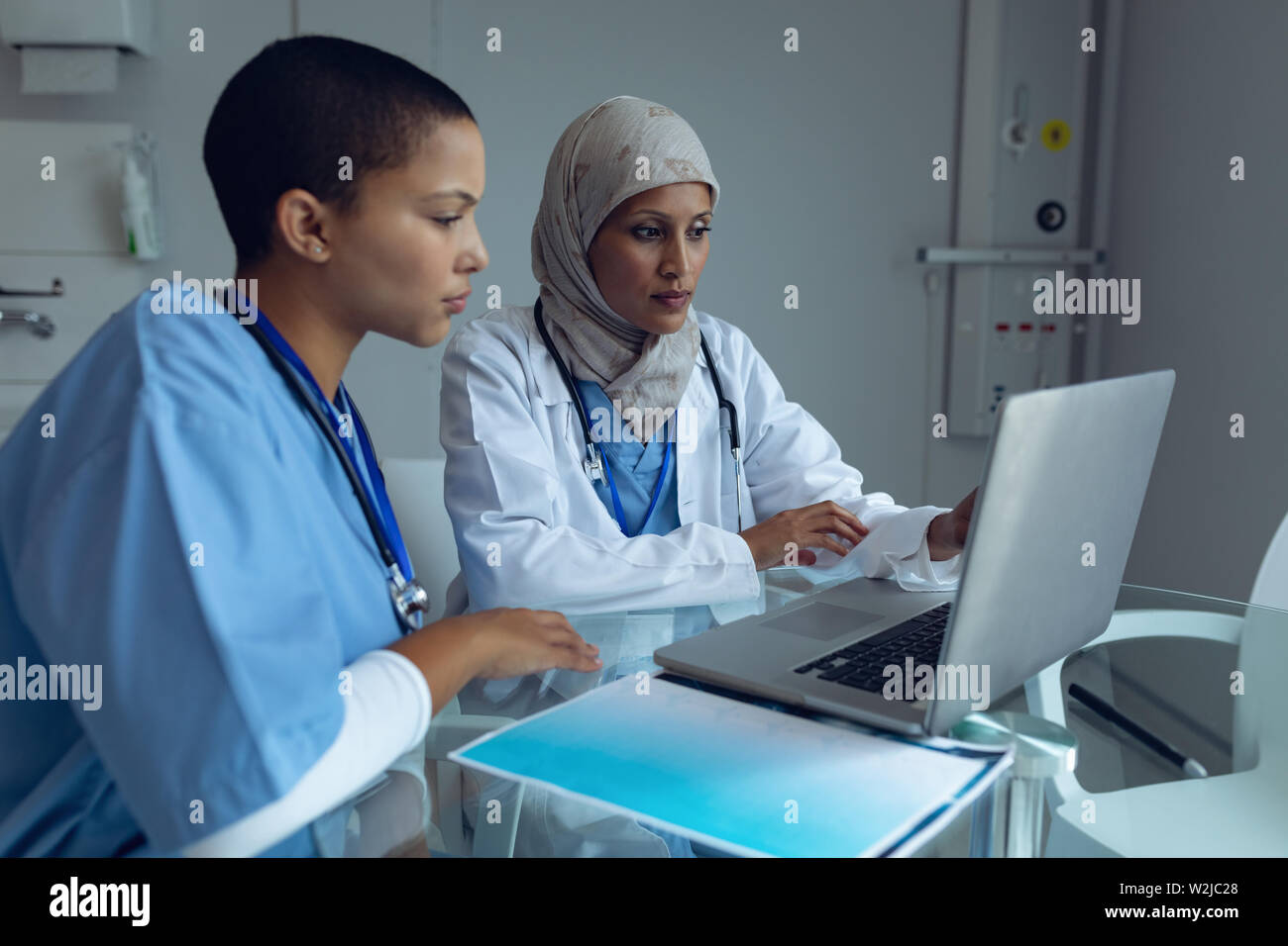 Female doctors using laptop in hospital Stock Photo - Alamy