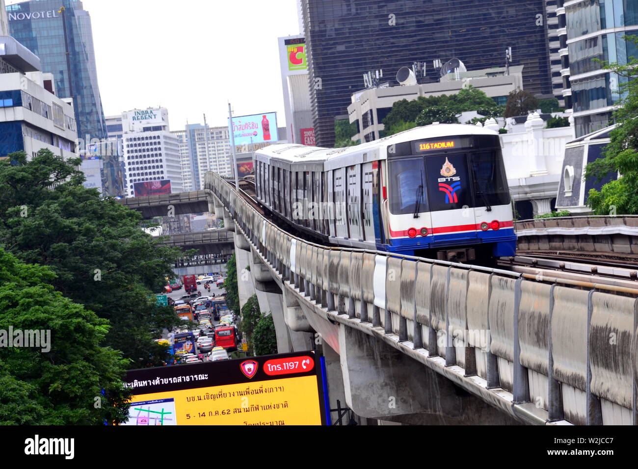 A skytrain approaches Ratchadamri Station on the Silom line, in central ...