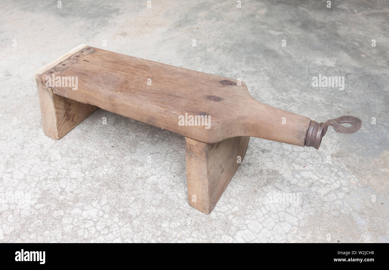 Old and traditional wooden coconut grater Stock Photo - Alamy