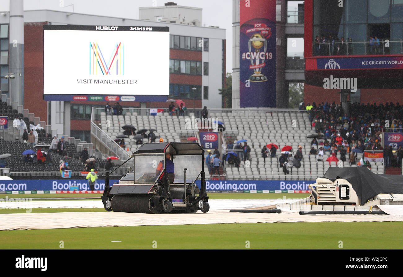 Ground staff work on the rain soaked ground during the ICC World Cup ...