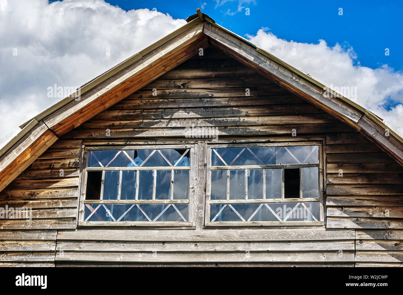 Gable End of an Aged Cottage with Horizontal Wooden Siding and Windows ...
