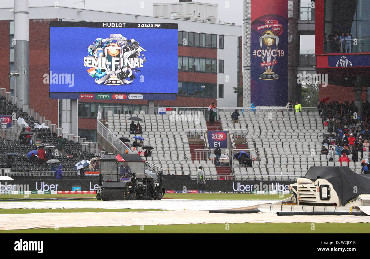 Ground staff work on the rain soaked ground during the ICC World Cup ...