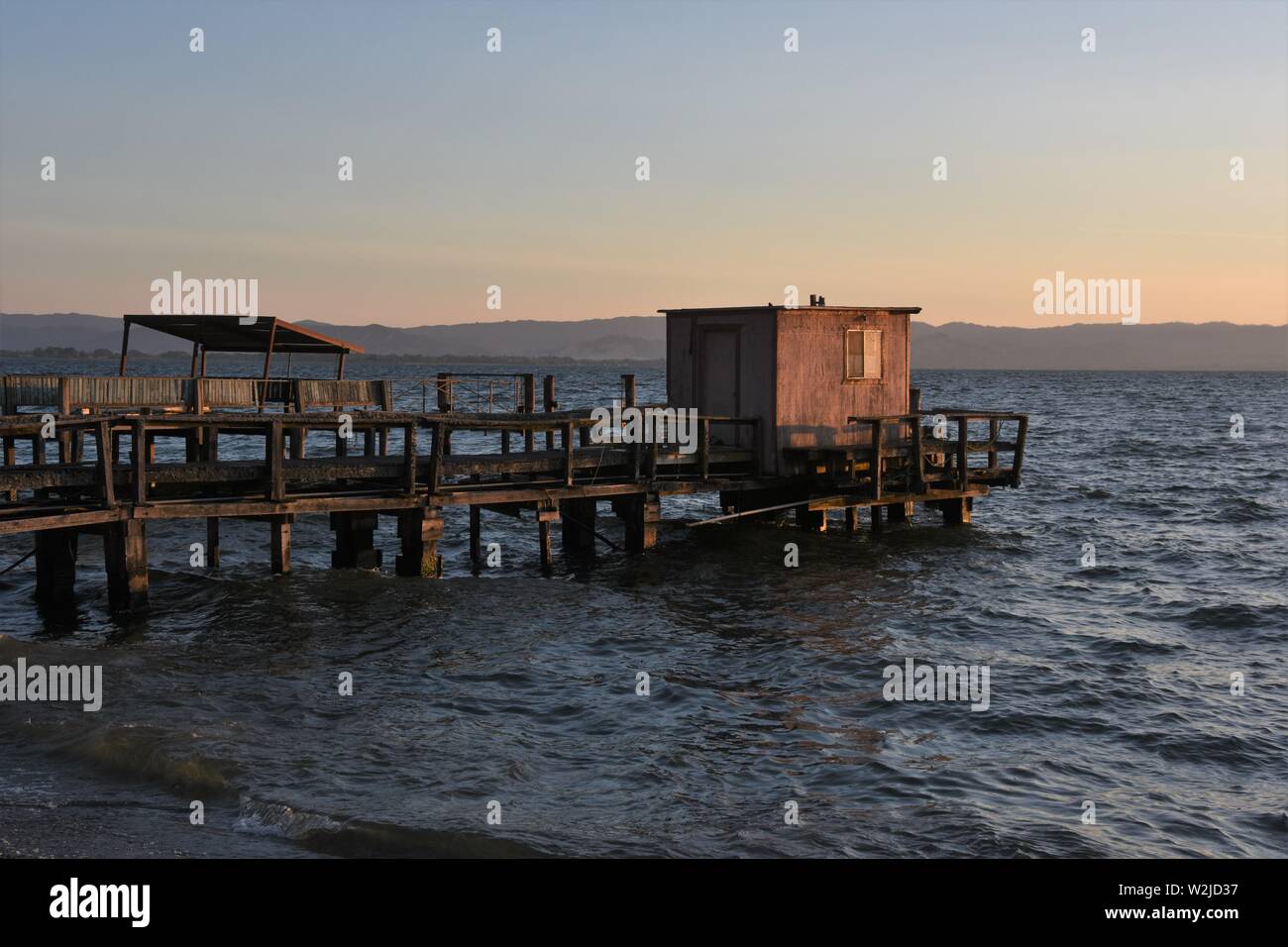 Old boat house on dock in Clear Lake California which is falling apart ...