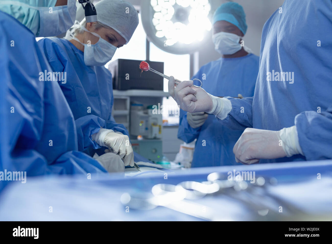 Surgeons performing surgery in operation theater Stock Photo - Alamy