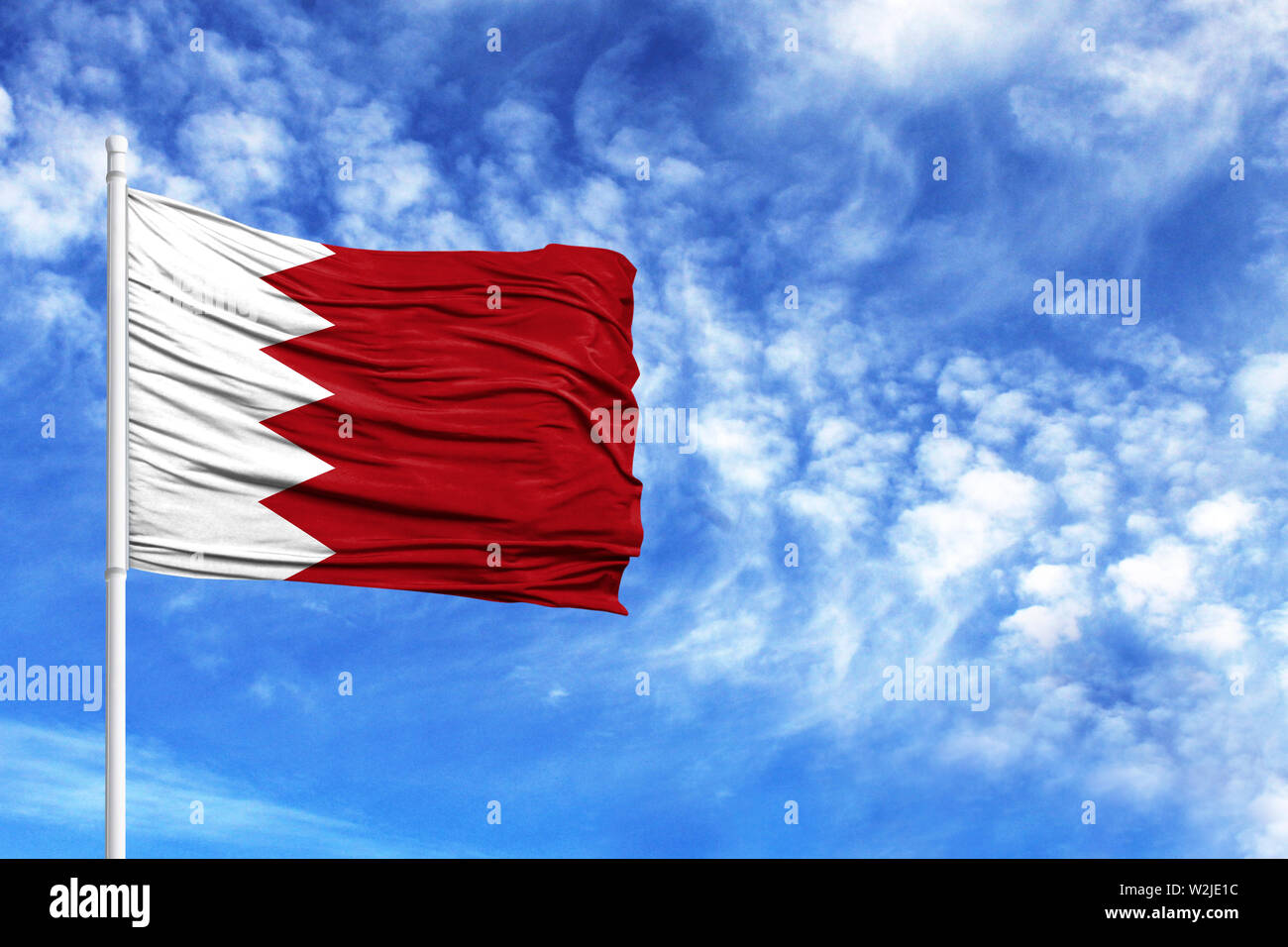 National flag of Bahrain on a flagpole in front of blue sky Stock Photo ...