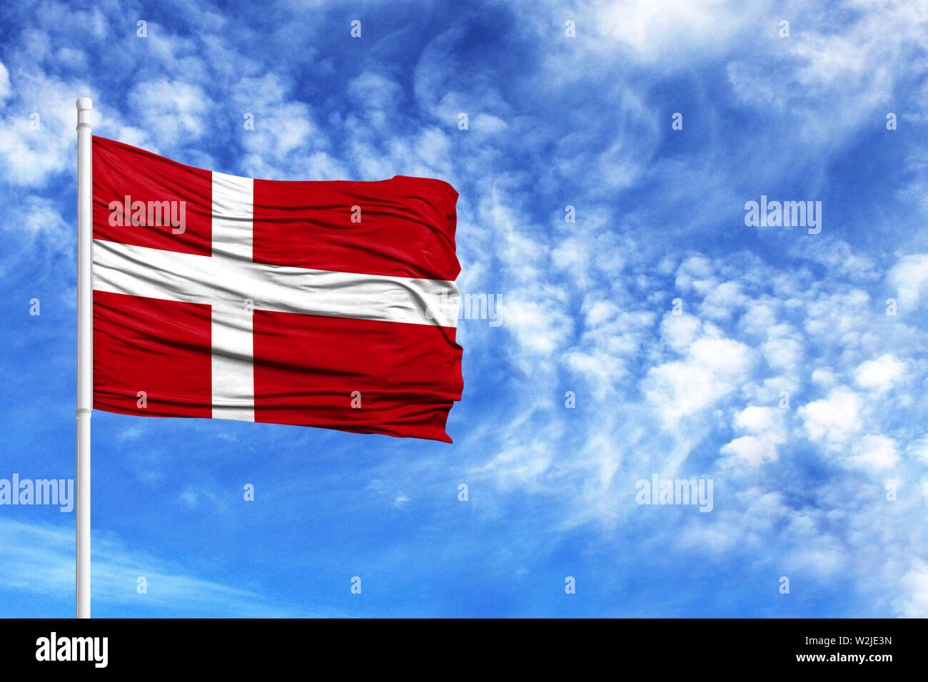National flag of Denmark on a flagpole in front of blue sky Stock Photo ...
