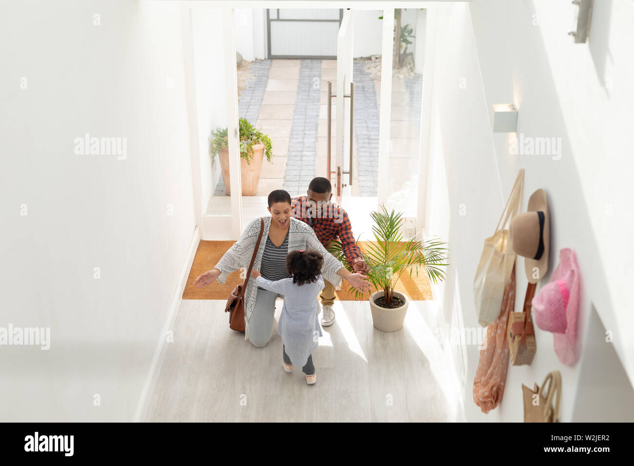 Parents embracing their son while entering at home Stock Photo - Alamy