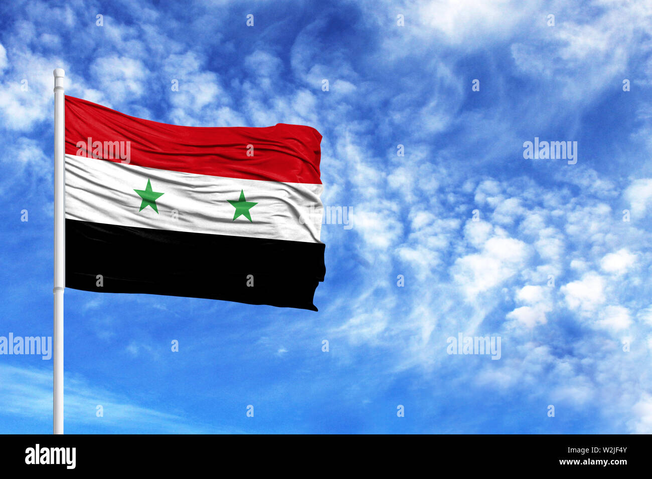 National flag of Syria on a flagpole in front of blue sky Stock Photo ...