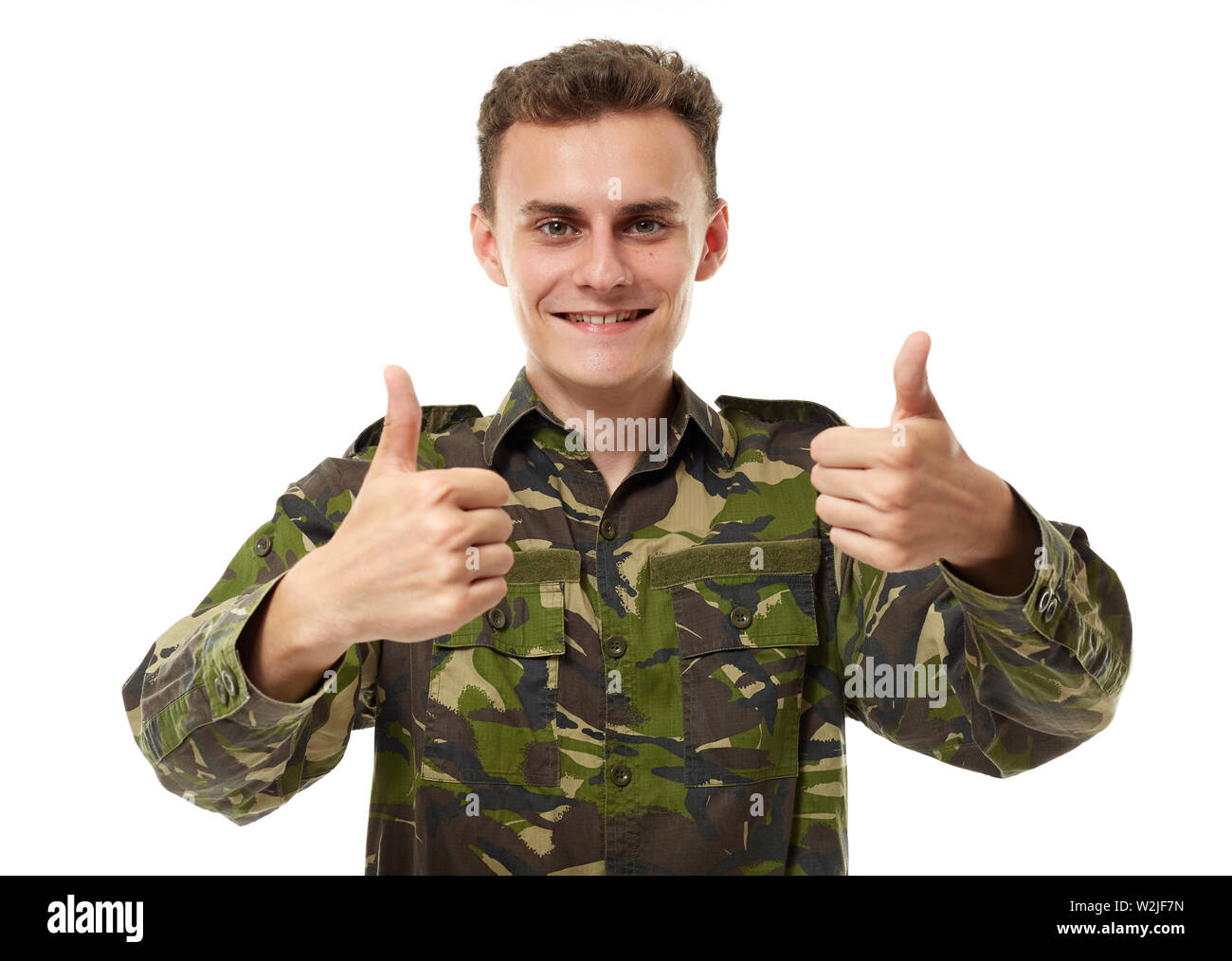 Military guy showing double thumbs up sign Stock Photo - Alamy