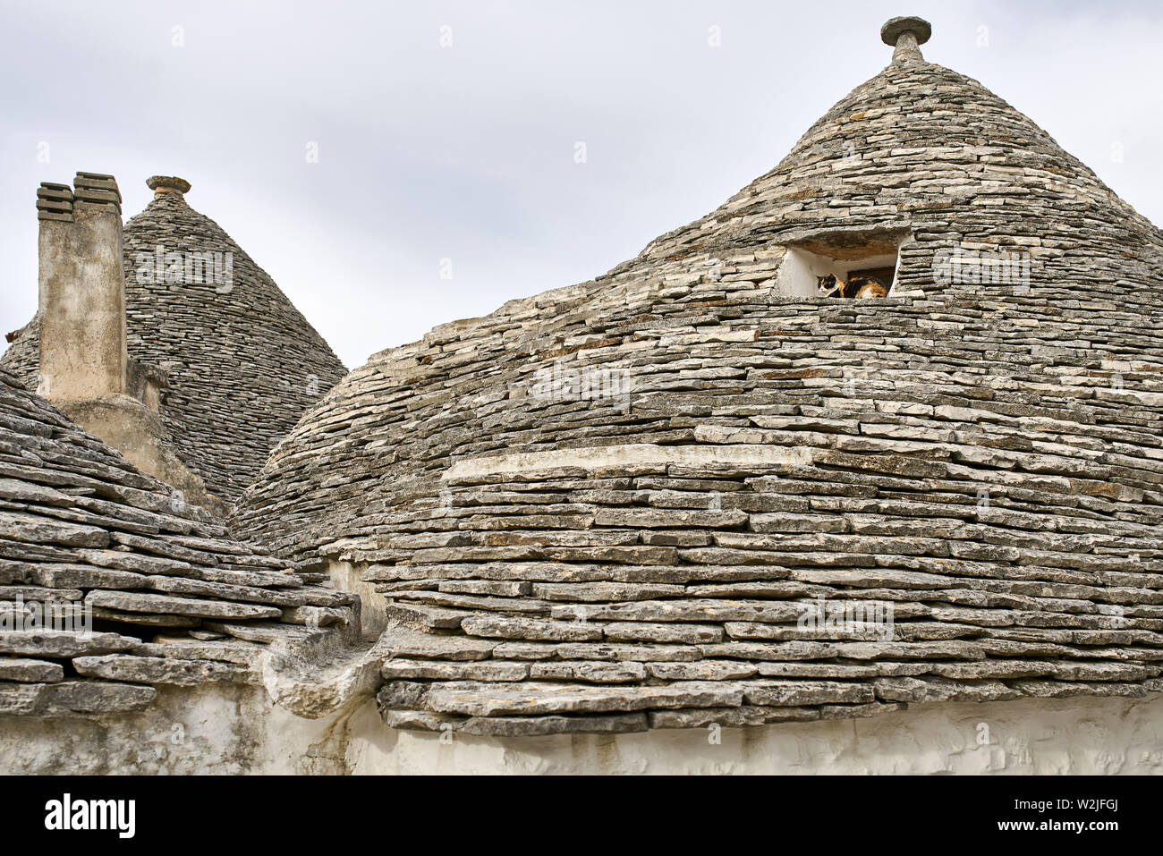 Conical roofs of the trulli houses on the sky background in Alberobello ...